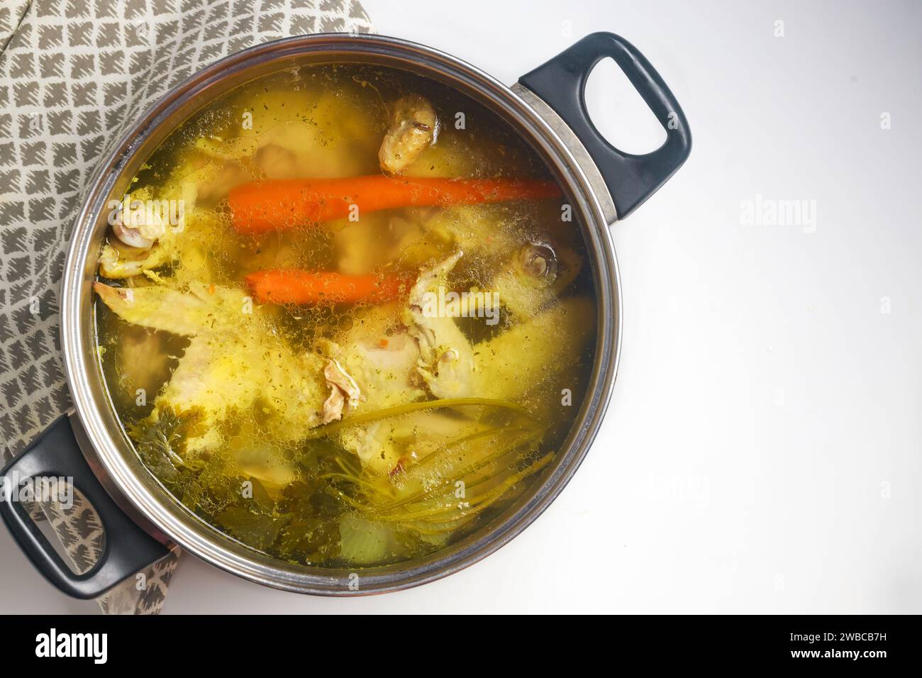 Using metal pot to cook chicken broth with meat and vegetables Stock ...