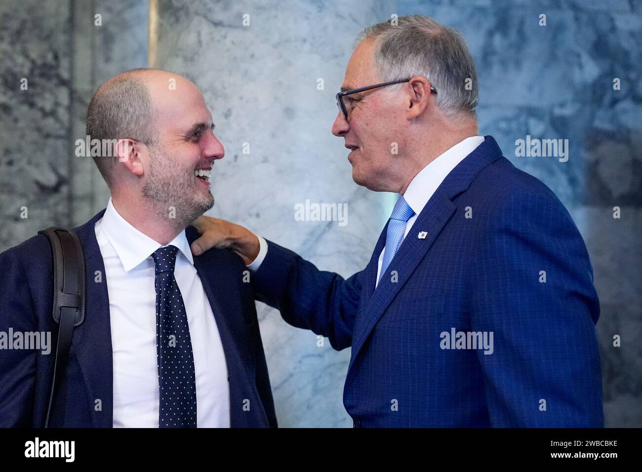 Washington Gov. Jay Inslee, right, greets Sen. Drew Hansen, D ...