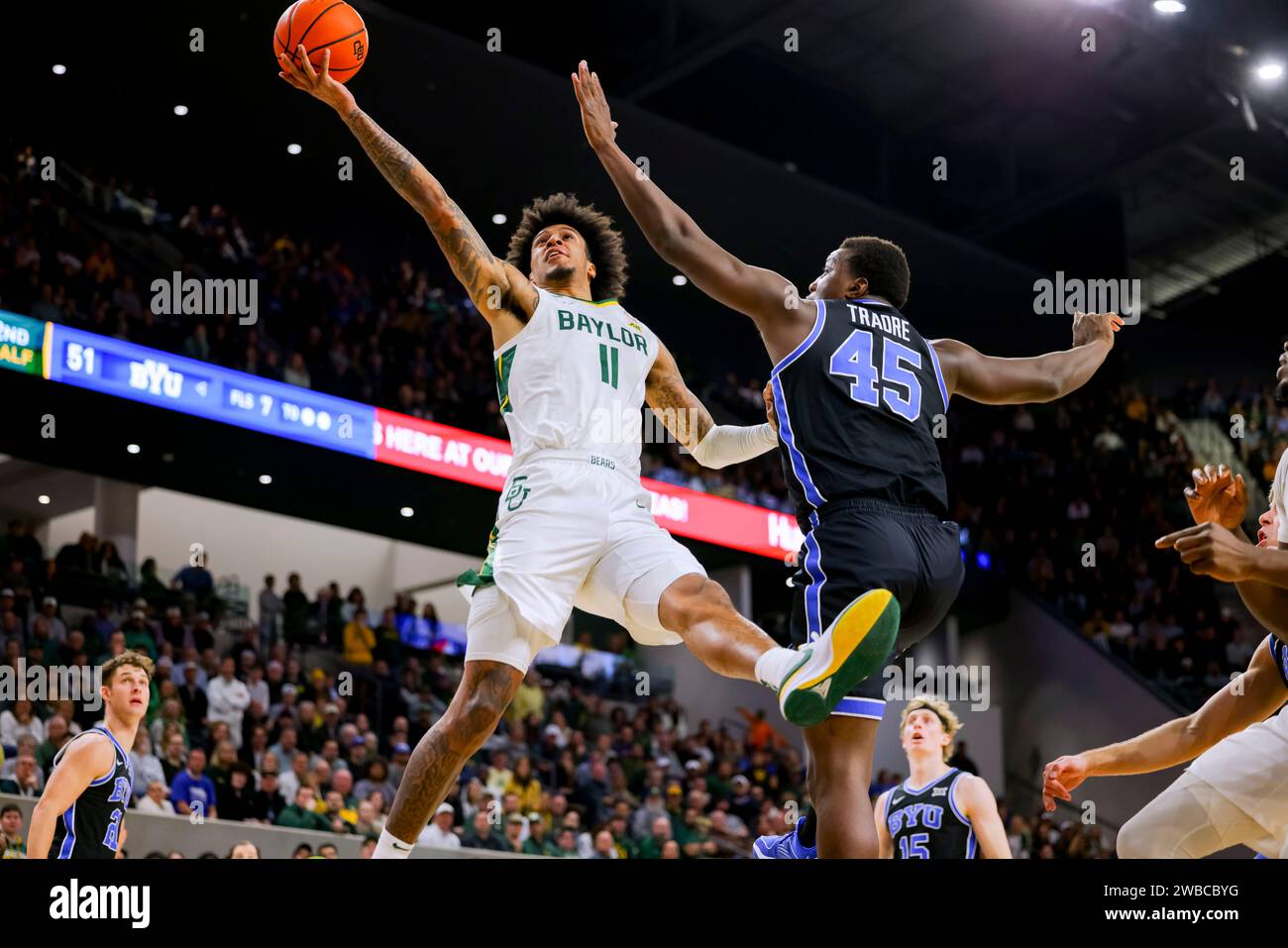 Baylor forward Jalen Bridges (11) scores while avoiding BYU forward ...