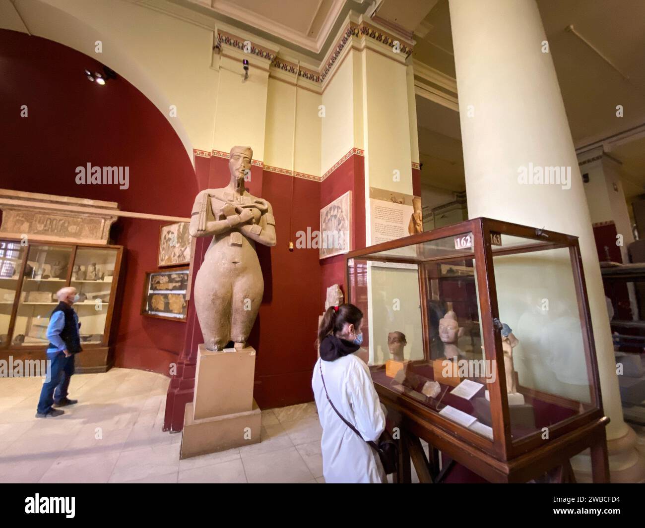 Cairo, Egypt. 08th Jan, 2022. A visitors examine ancient artifacts in the hall of the Museum of ...
