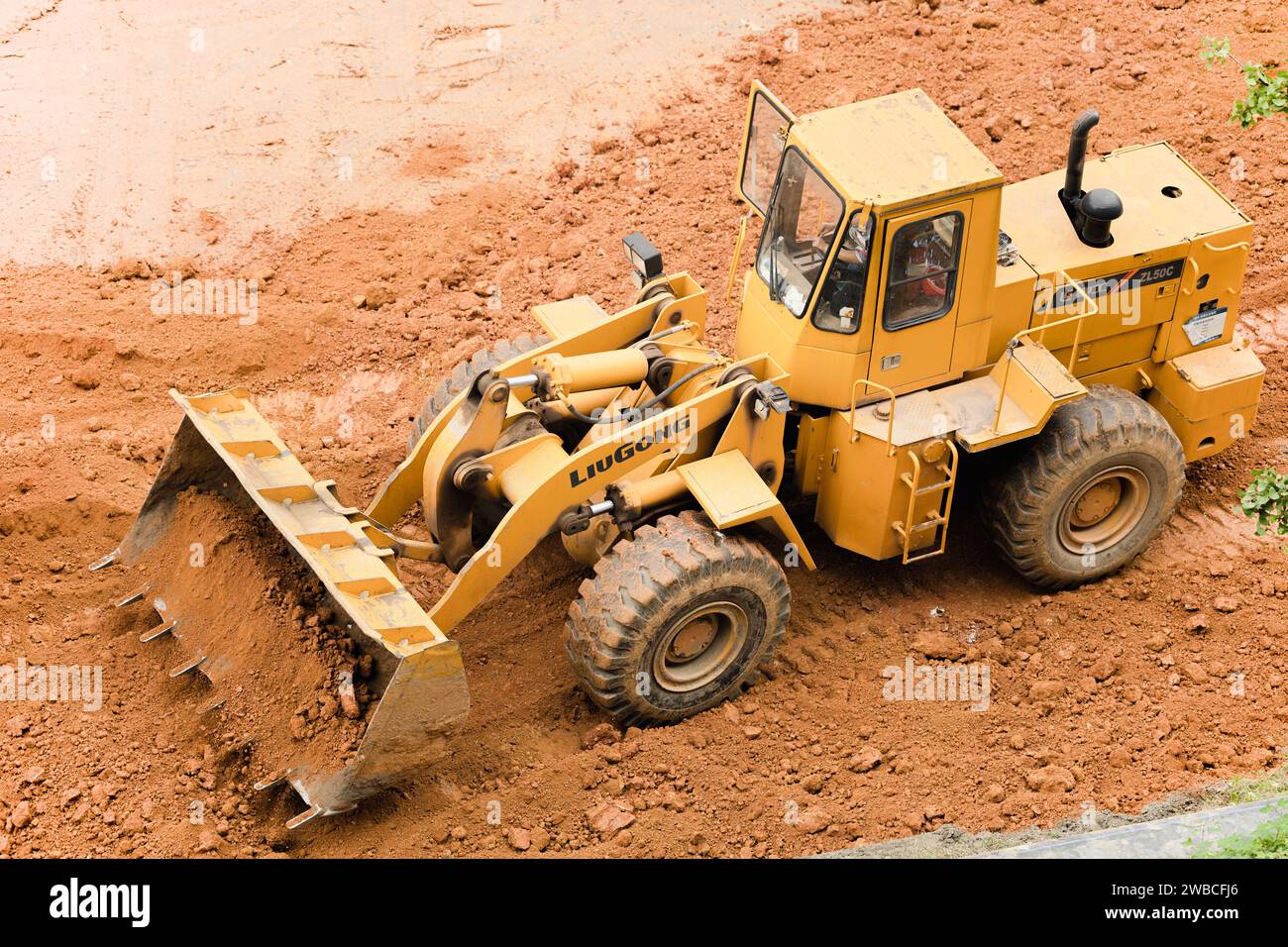 Excavator digging the land Stock Photo - Alamy