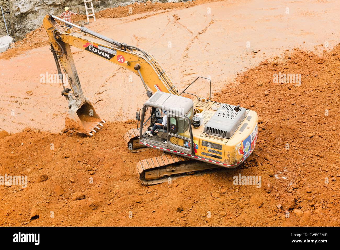 Excavator digging the land Stock Photo - Alamy
