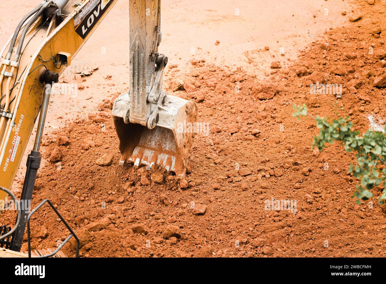 Excavator digging the land Stock Photo - Alamy