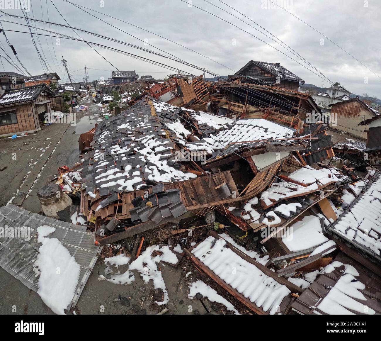 Collapsed buildings are seen at a disaster area in Suzu City, Ishikawa ...