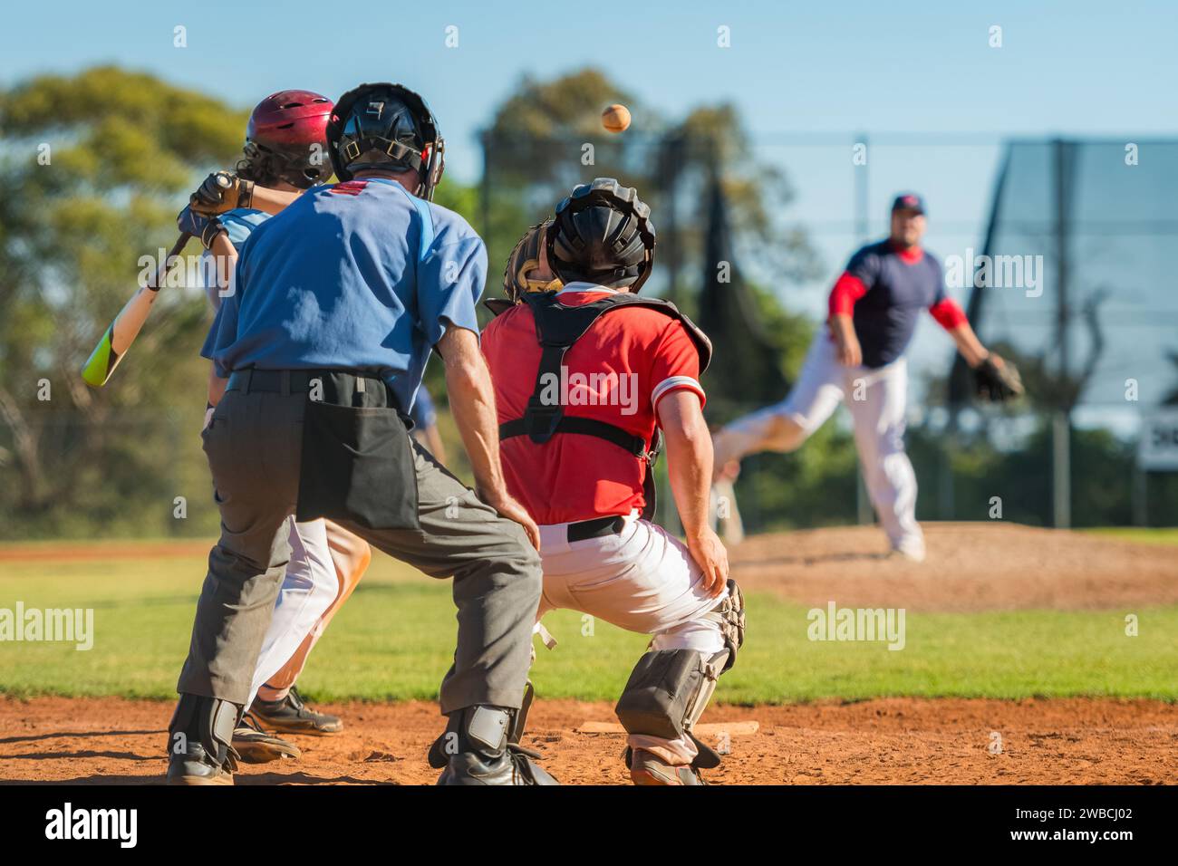 Men playing baseball game. Batter getting ready to hit a pitch during ...