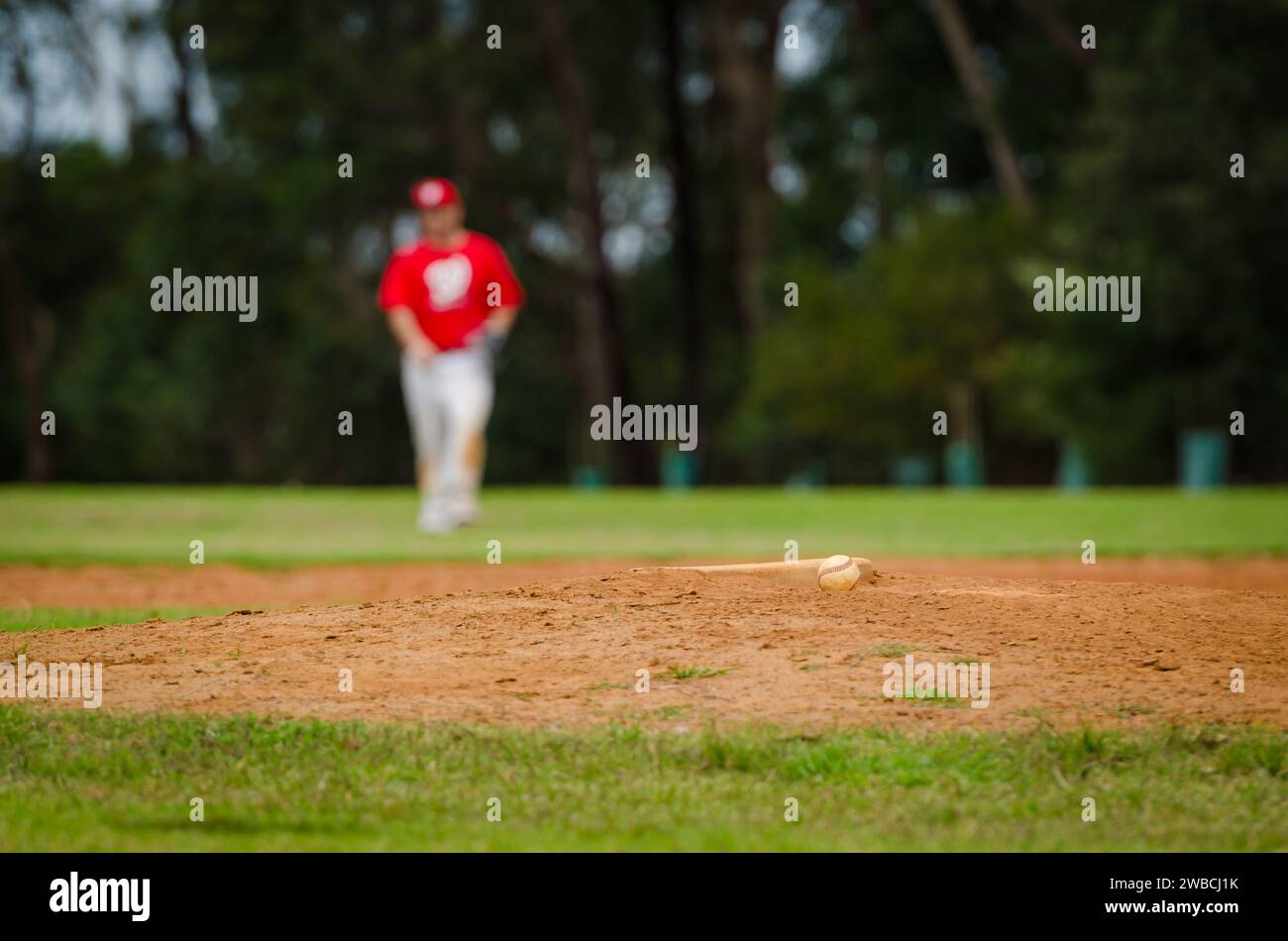Baseball ball lying on the diamond next to the pitching rubber on the ...