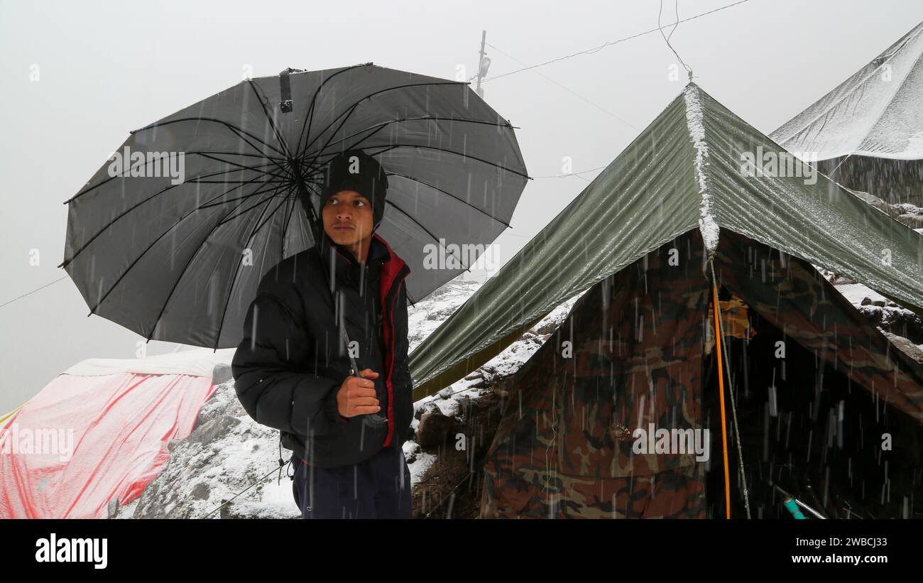 Man with umbrella in Himalayan state Uttarakhand India. To predict the ...