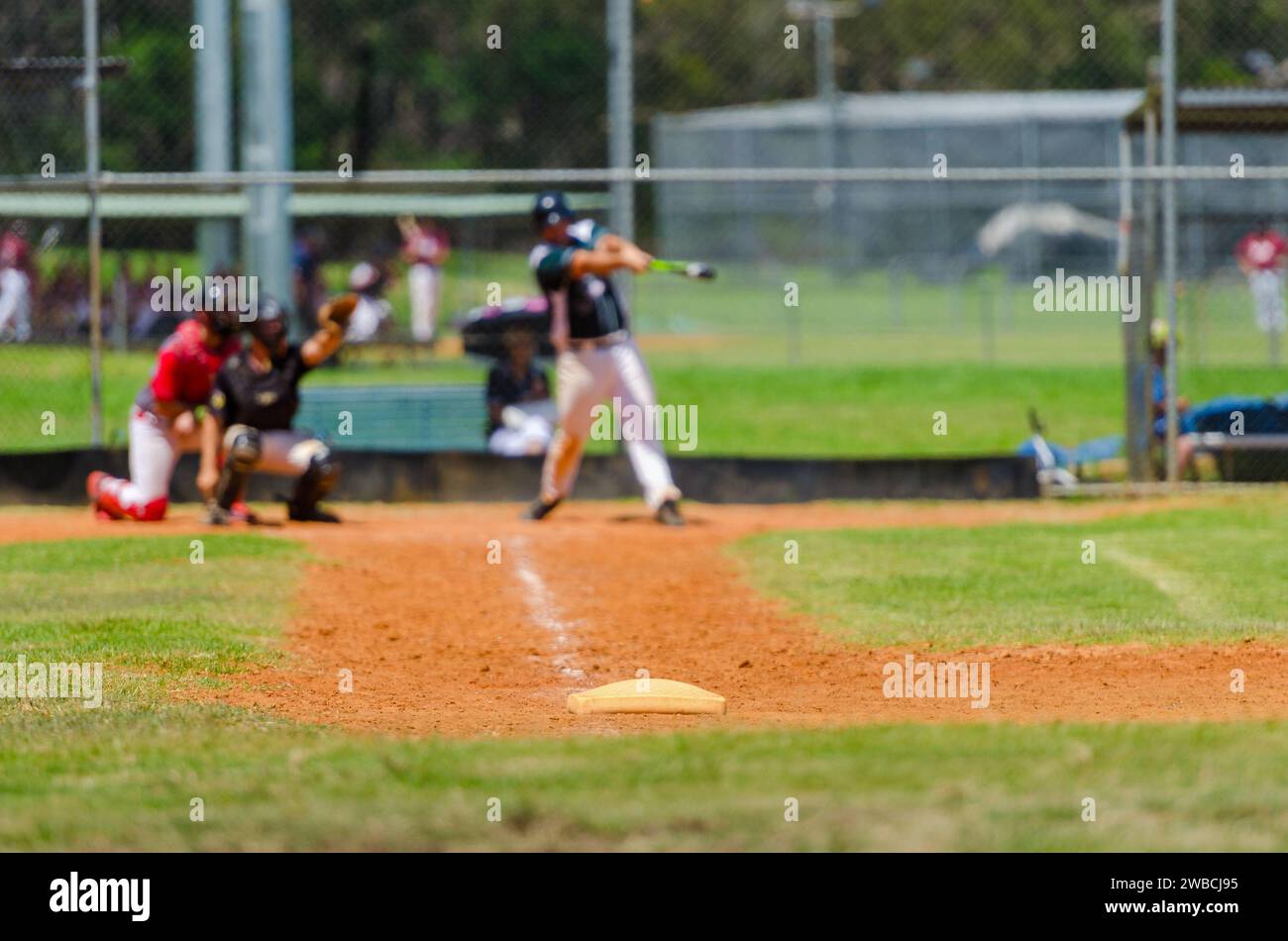 Men playing baseball game. Batter trying to hit a pitch during ballgame ...