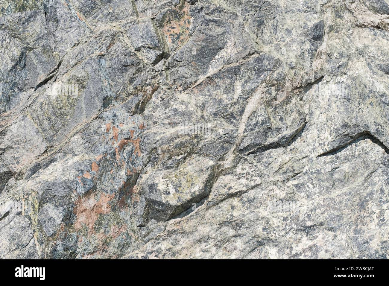 Texture of raw block of natural stone of greenish tint with brown ...