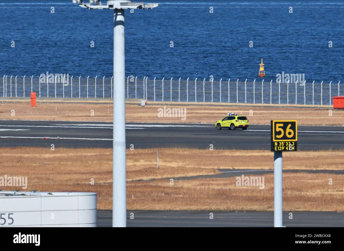 A Civil Aviation Bureau (JCAB) patrol car inspects the runway on the ...