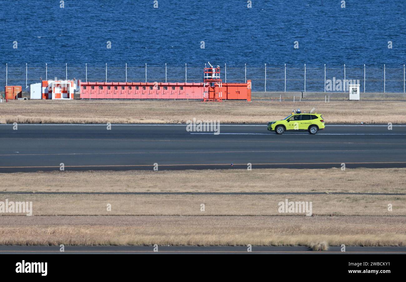 A Civil Aviation Bureau (JCAB) patrol car inspects the runway on the ...