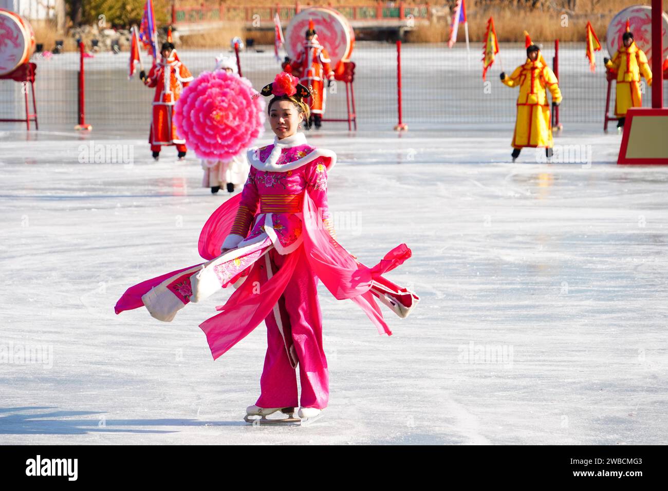 Performers dance on the ice rink in the Old Summer Palace in Beijing ...