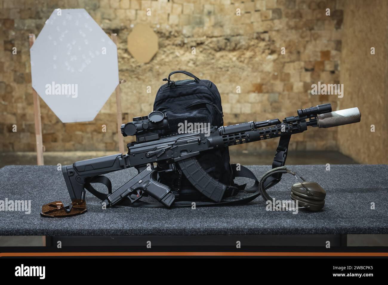 Tactical shooting and firearms in a shooting range, AKM rifle with ...