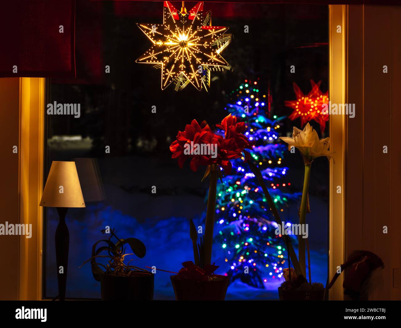 View of inspiring window decorations at Christmas time. Stars, flowers ...