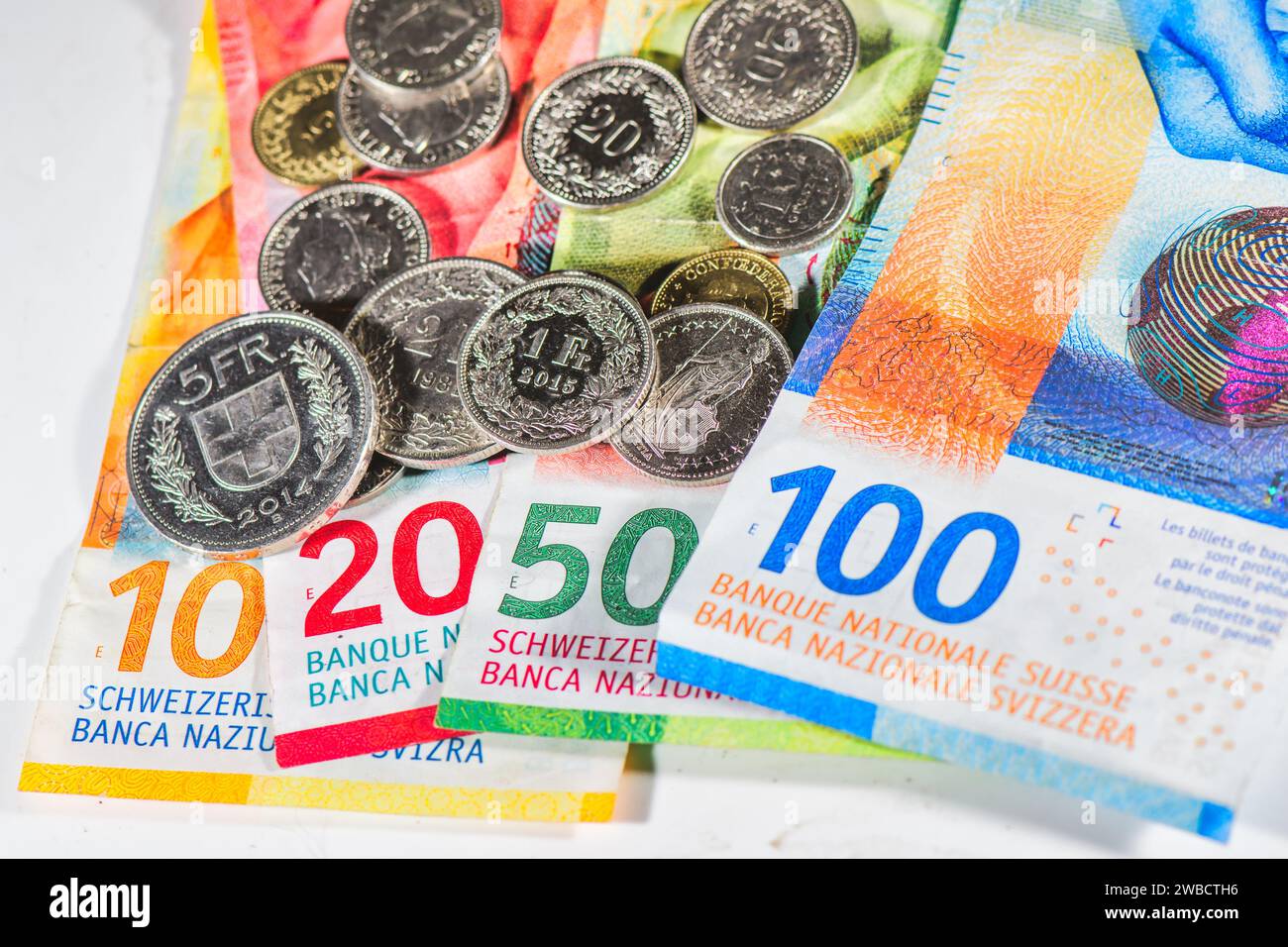 Swiss Franc banknotes and coins on white background Stock Photo - Alamy