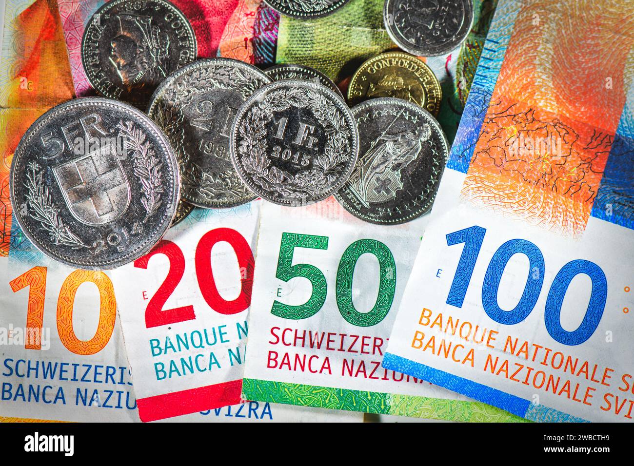 Swiss Franc banknotes and coins on white background Stock Photo - Alamy
