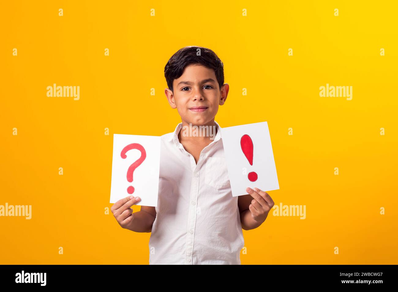 Portrait of kid boy holding question mark card in hand. Education and curiosity concept Stock ...