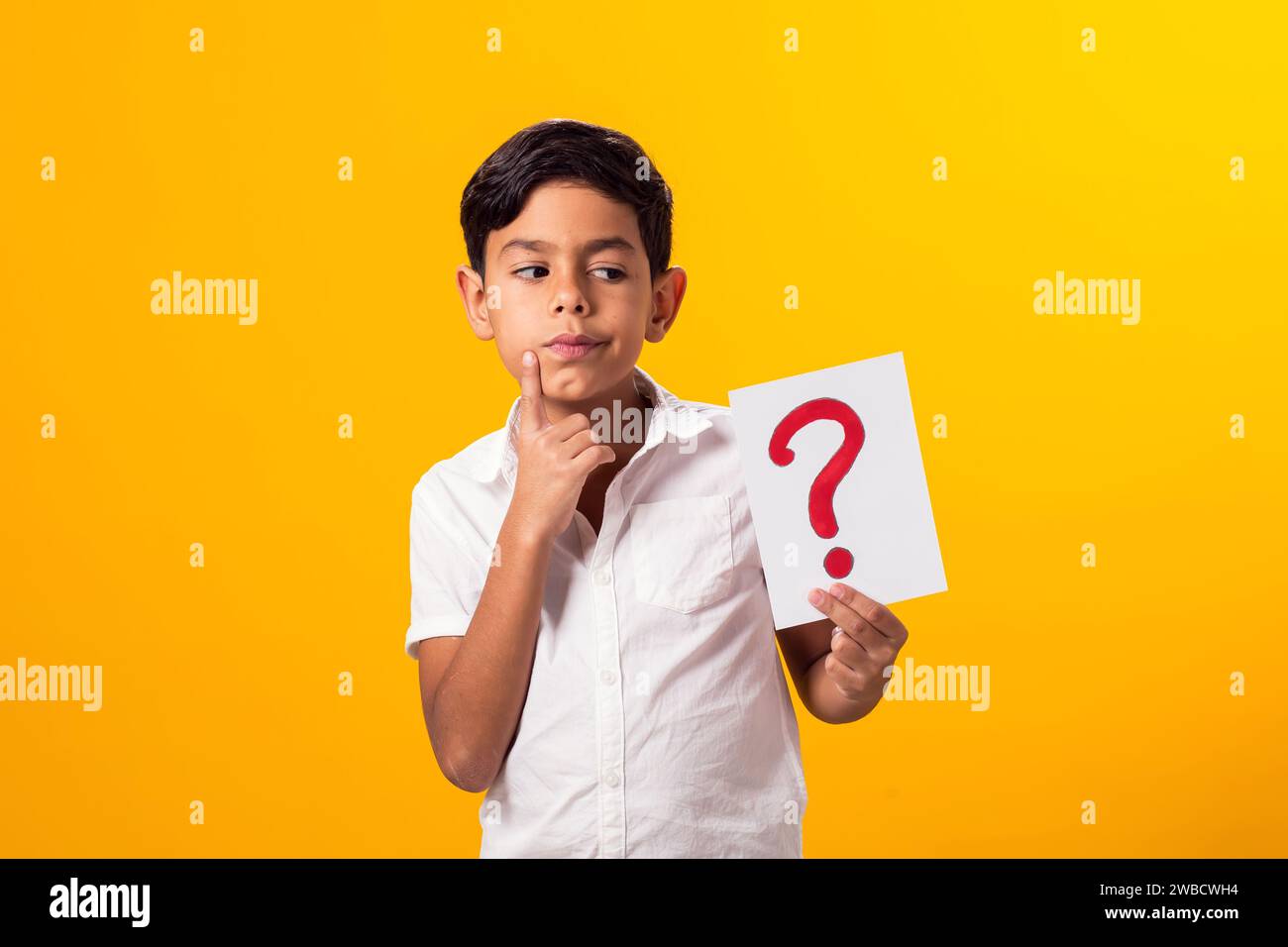 Portrait of kid boy holding question mark card in hand. Education ...