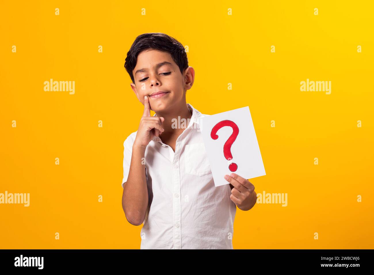 Portrait of kid boy holding question mark card in hand. Education ...