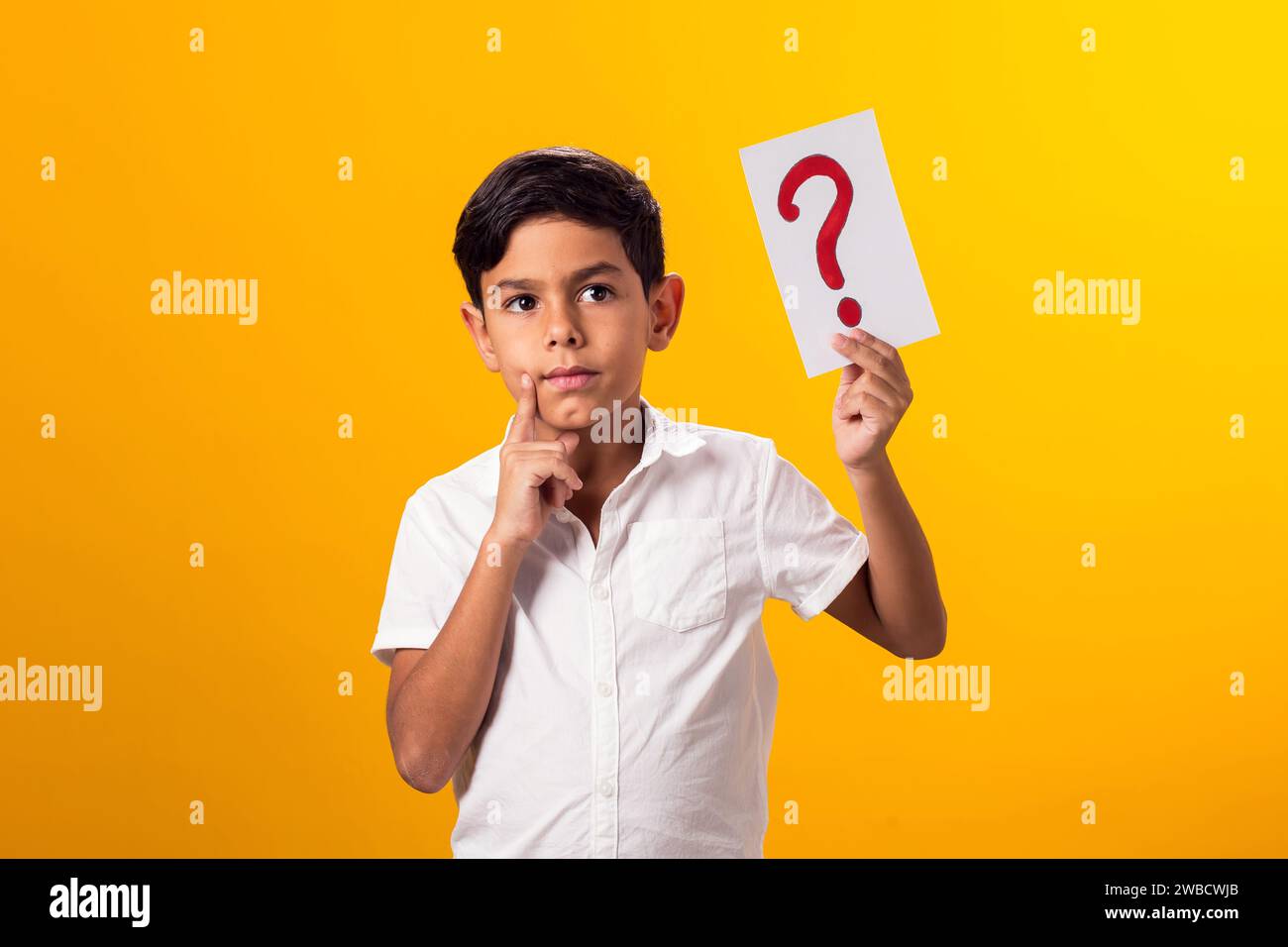 Portrait of kid boy holding question mark card in hand. Education ...