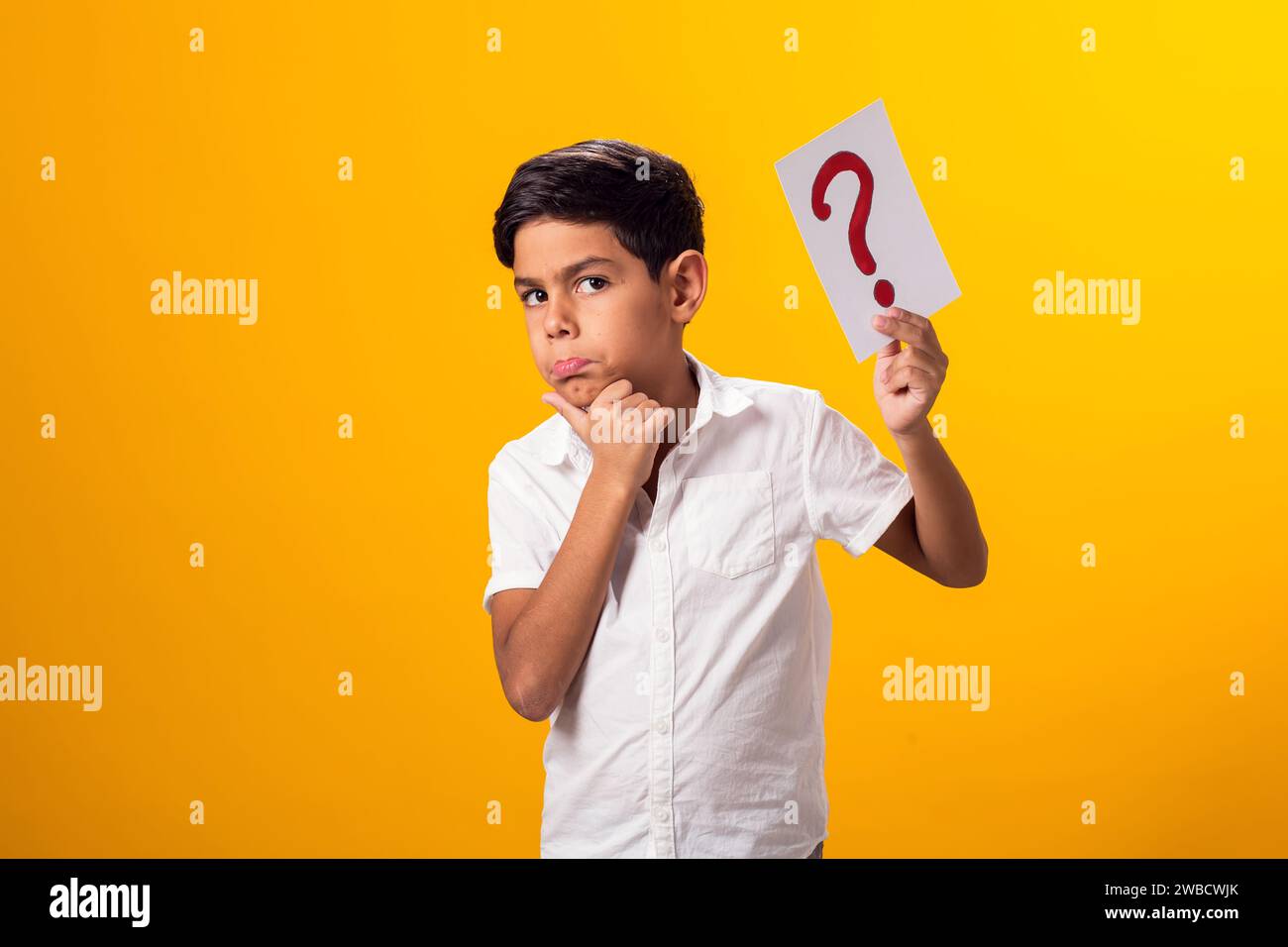 Portrait of kid boy holding question mark card in hand. Education ...
