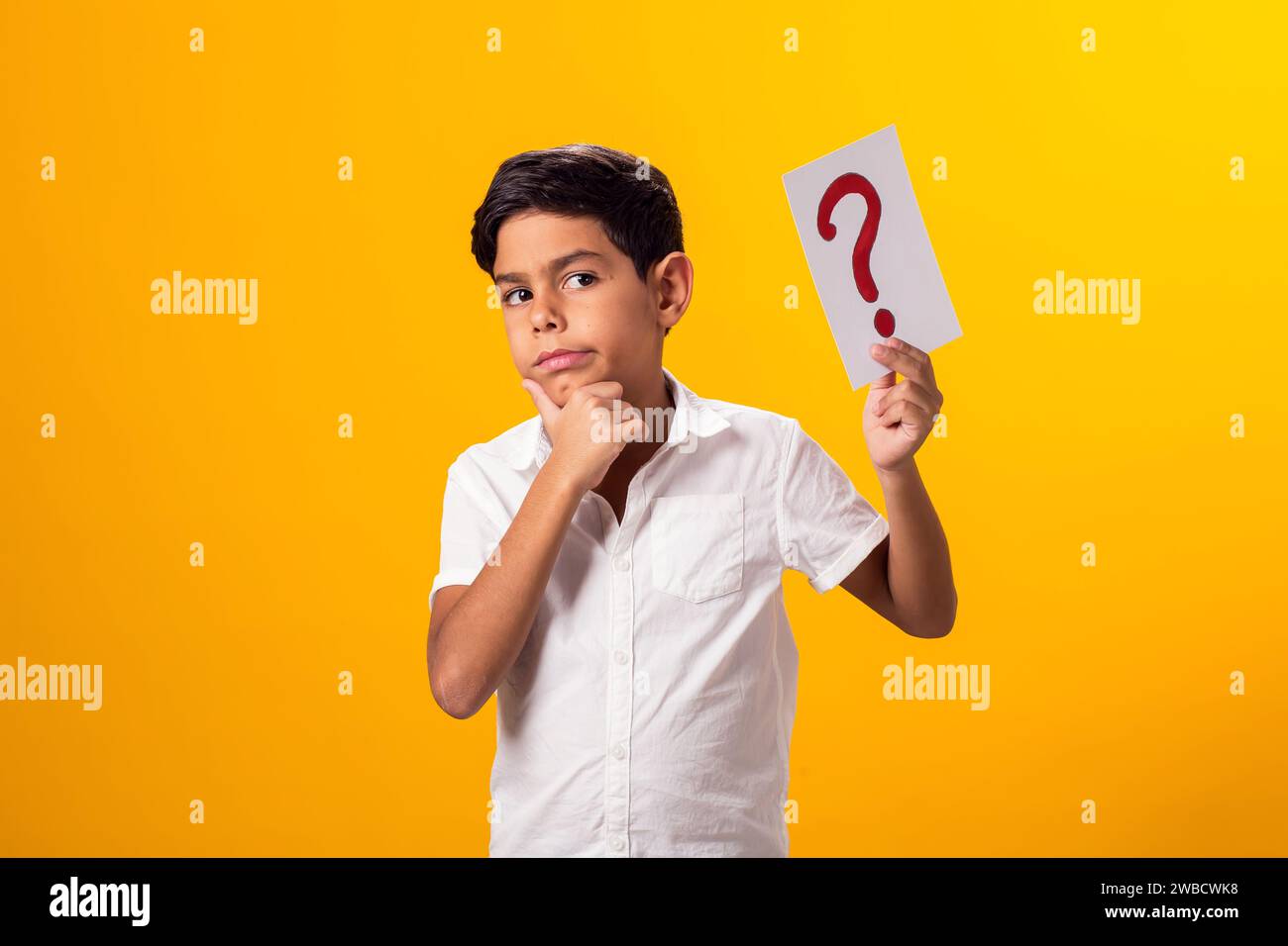 Portrait of kid boy holding question mark card in hand. Education ...
