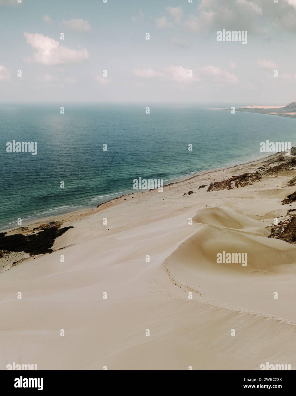 Aerial view of Arher Beach in Socotra, Yemen, showcasing pristine white sand dunes meeting the ...