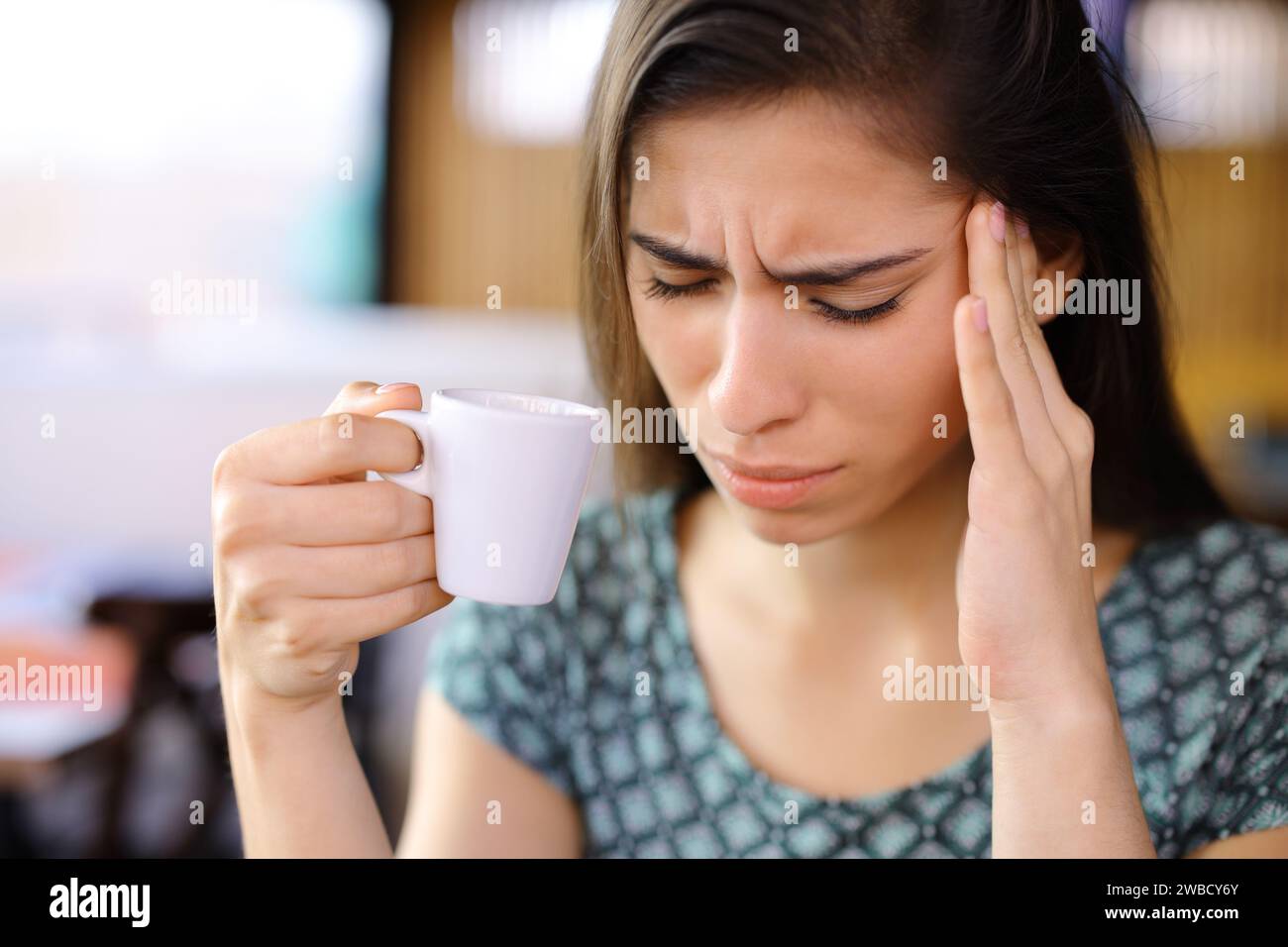 Woman drinking coffee suffering head ache in a restaurant Stock Photo ...