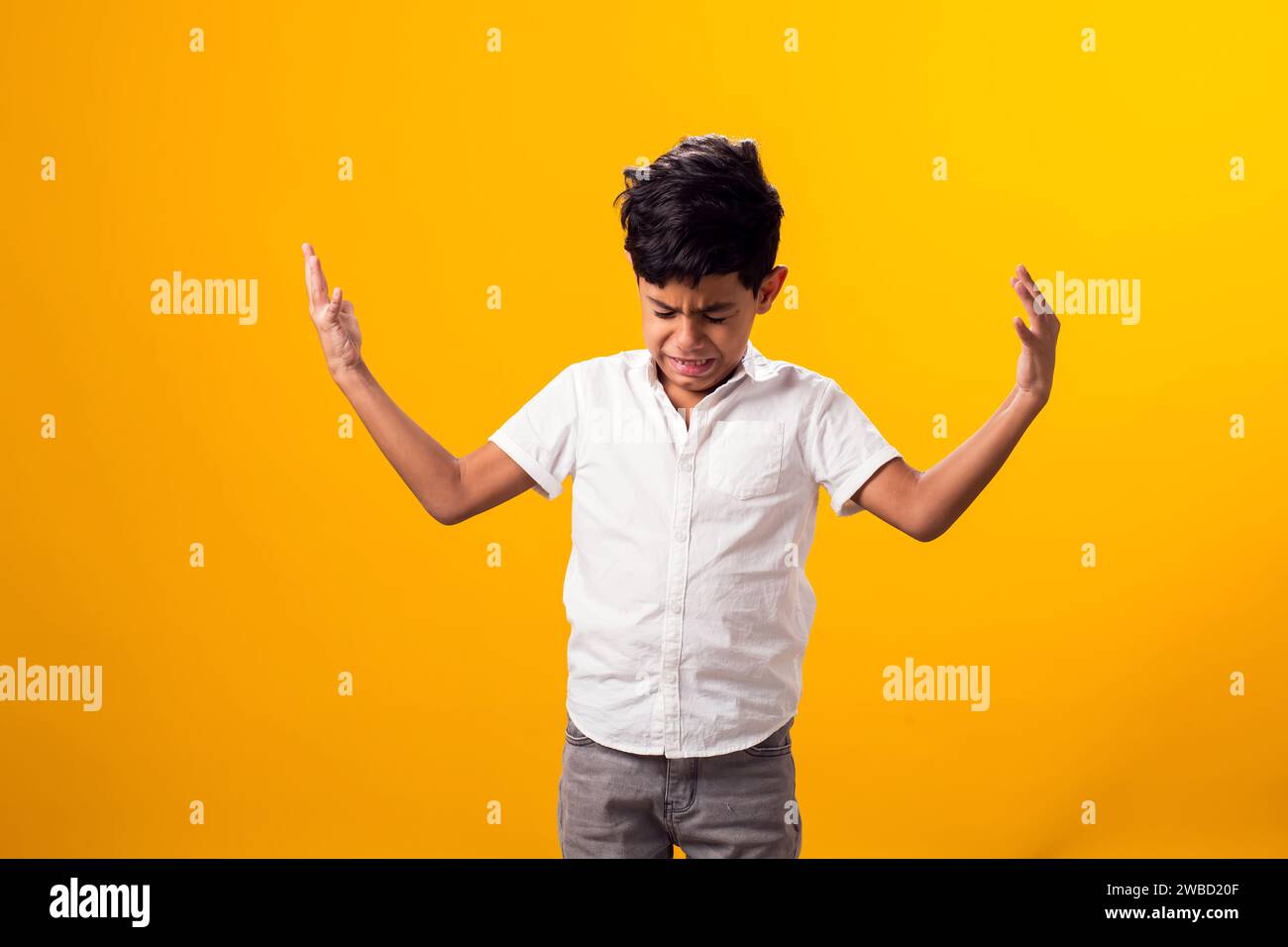 Portrait of angry kid boy over yellow background. Stress and aggression ...