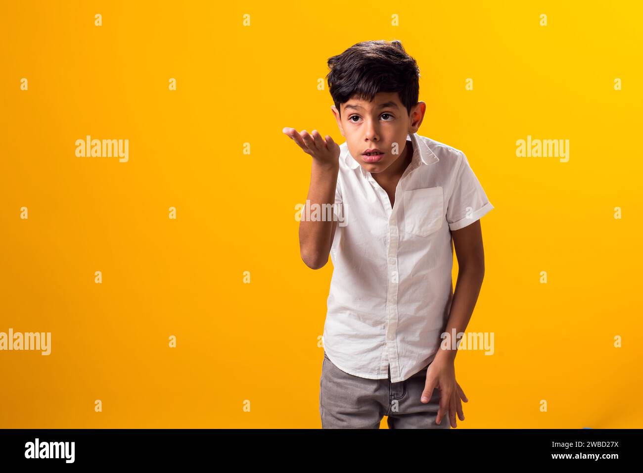 Portrait of surprised kid boy over yellow background. Astonished ...