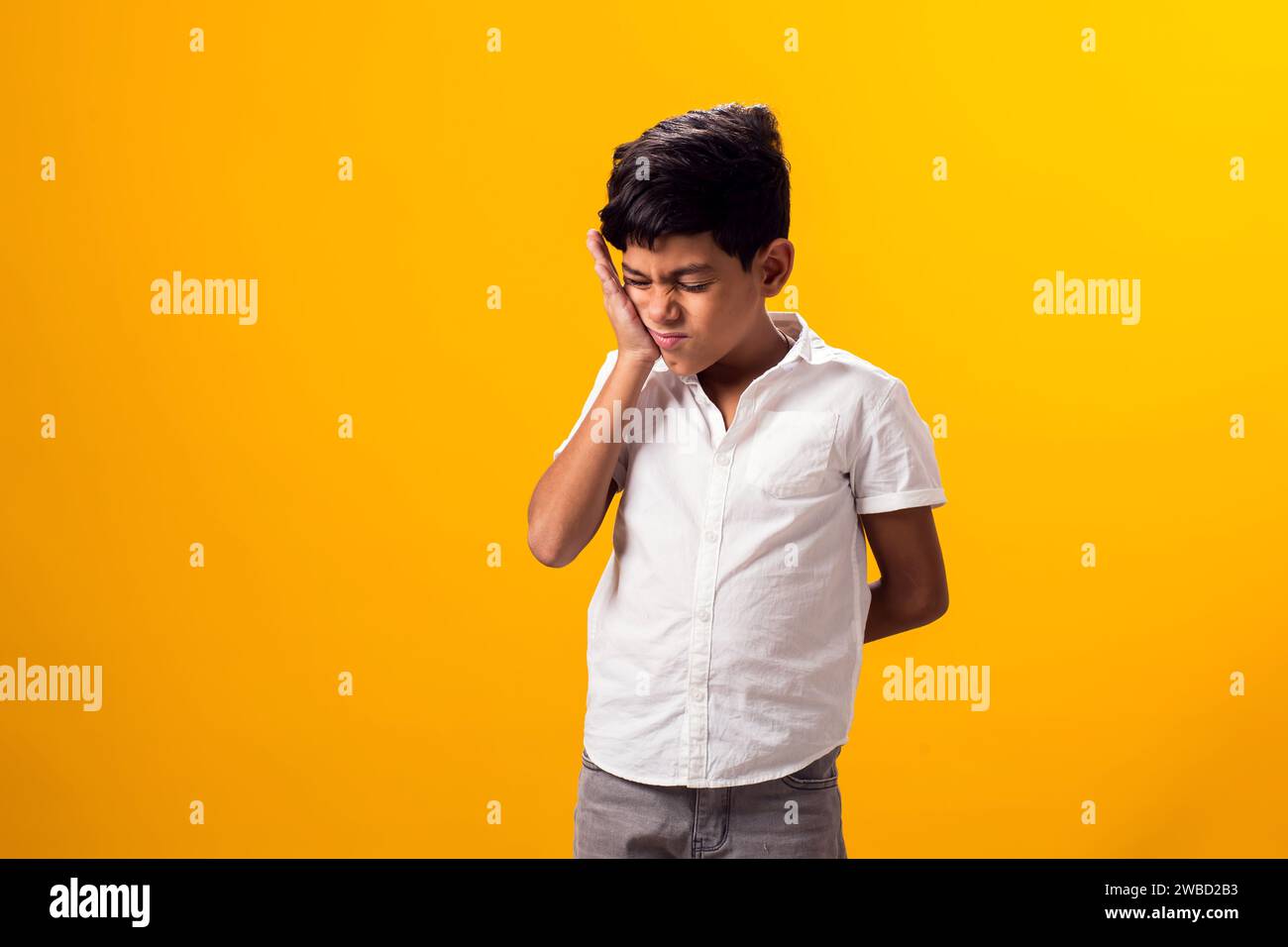 Portrait of kid boy feeling toothache, holding hand on his cheek ...
