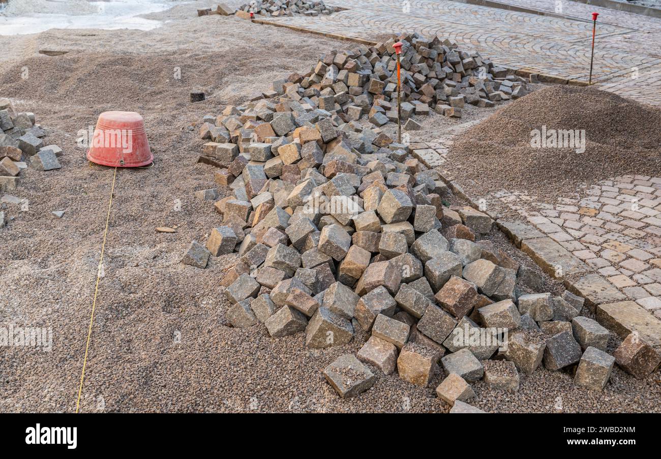 Resurfacing the road surface, manual laying of porphyry cubes on the ...