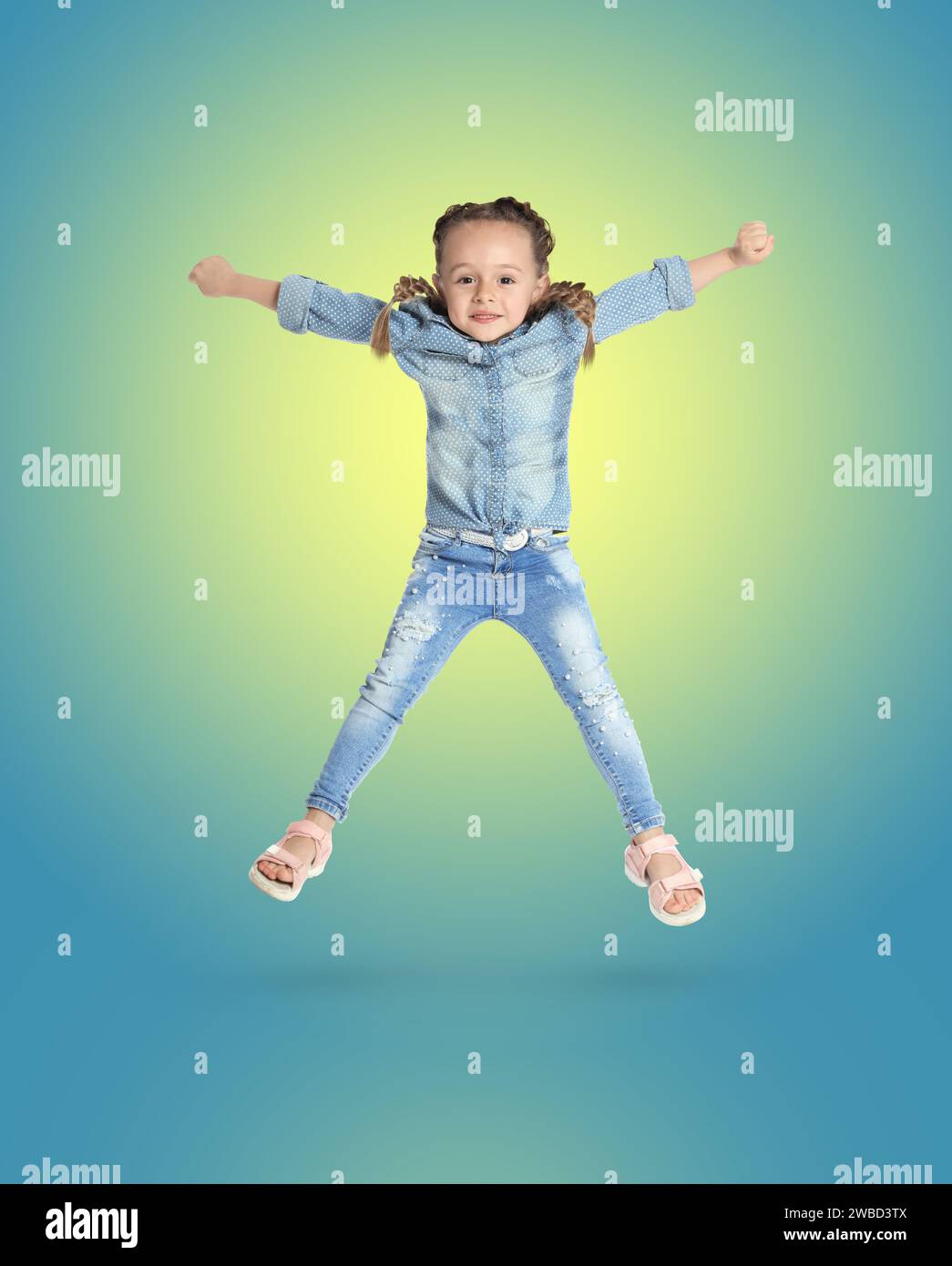 Happy cute girl jumping on color gradient background Stock Photo - Alamy