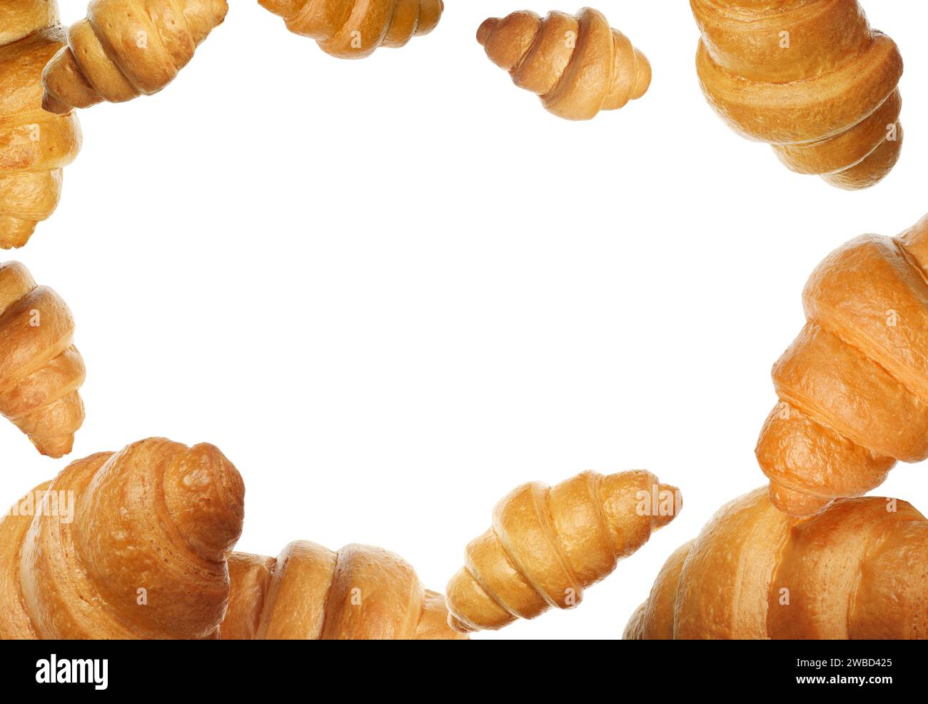 Crusty golden croissants falling on white background Stock Photo - Alamy