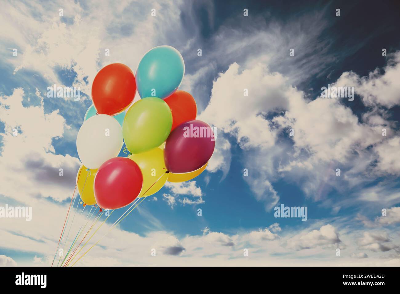 Colorful balloons flying in blue sky with clouds. Space for text Stock ...