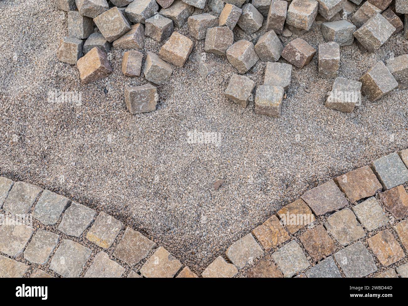 Resurfacing the road surface, manual laying of porphyry cubes on the ...