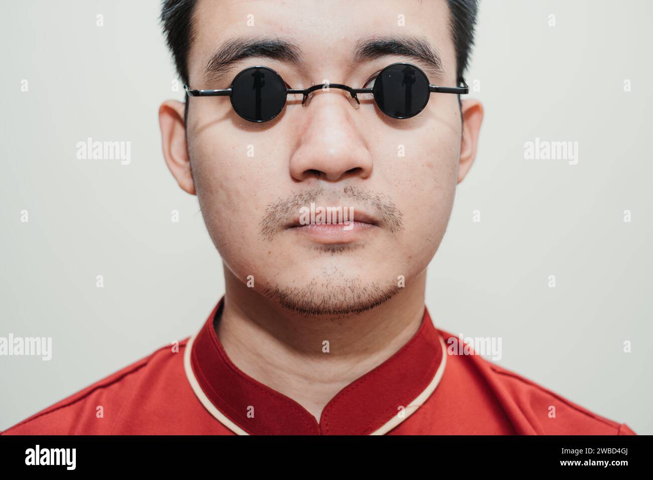 Portrait of Asian man wearing Cheongsam and black rounded vintage ...