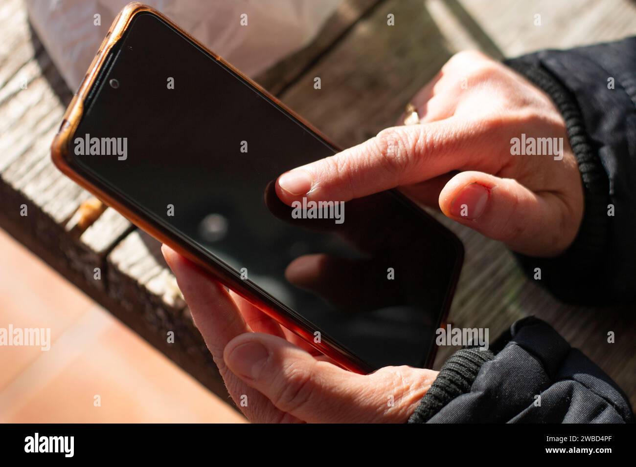 Woman's hand touching the black screen of a mobile phone Stock Photo ...