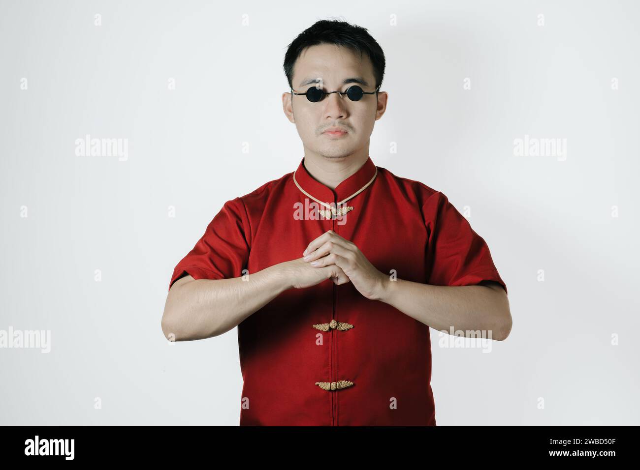 Gesture of congratulation of Asian man wearing Cheongsam on Lunar New ...