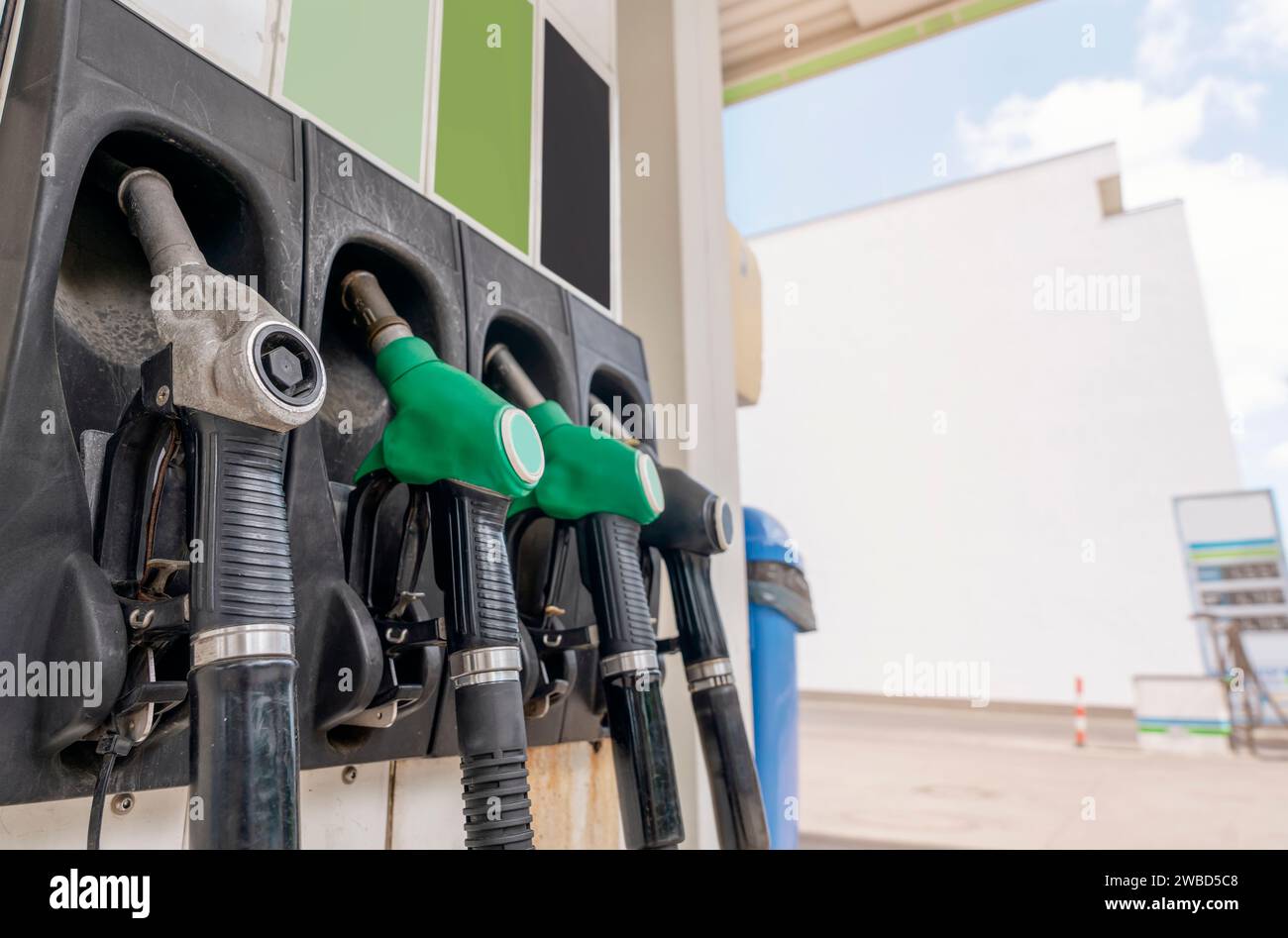 Close up of diesel and petrol fuel pistols at a gas station. The fuel ...