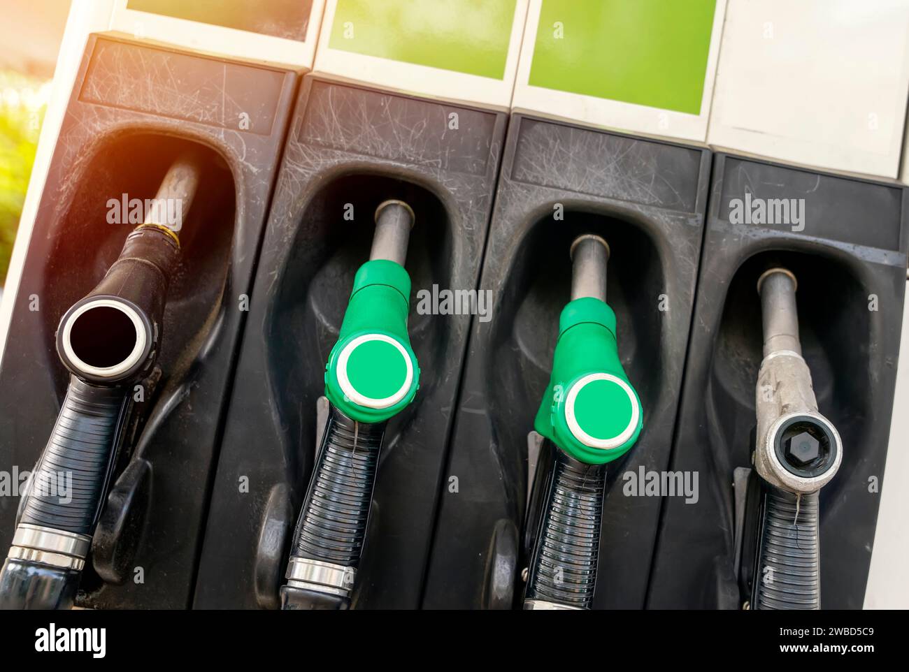 Close up of diesel and petrol fuel pistols at a gas station. The fuel ...