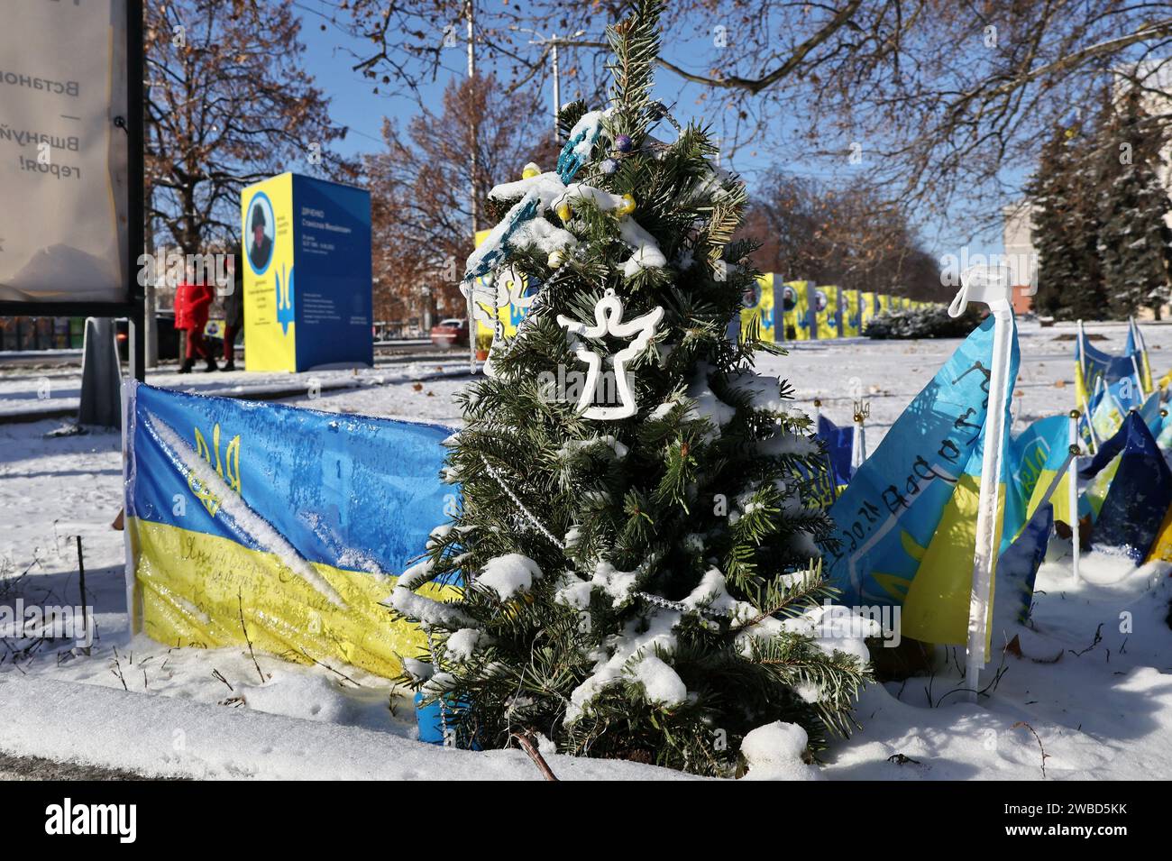 An improvised Christmas tree and Ukrainian flags are seen covered with ...