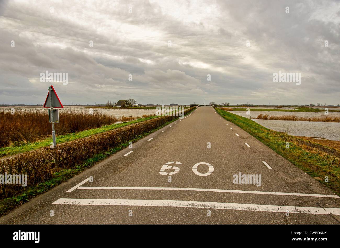 Werkendam, The Netherlands, December 29, 2024: asphalt road between the ...
