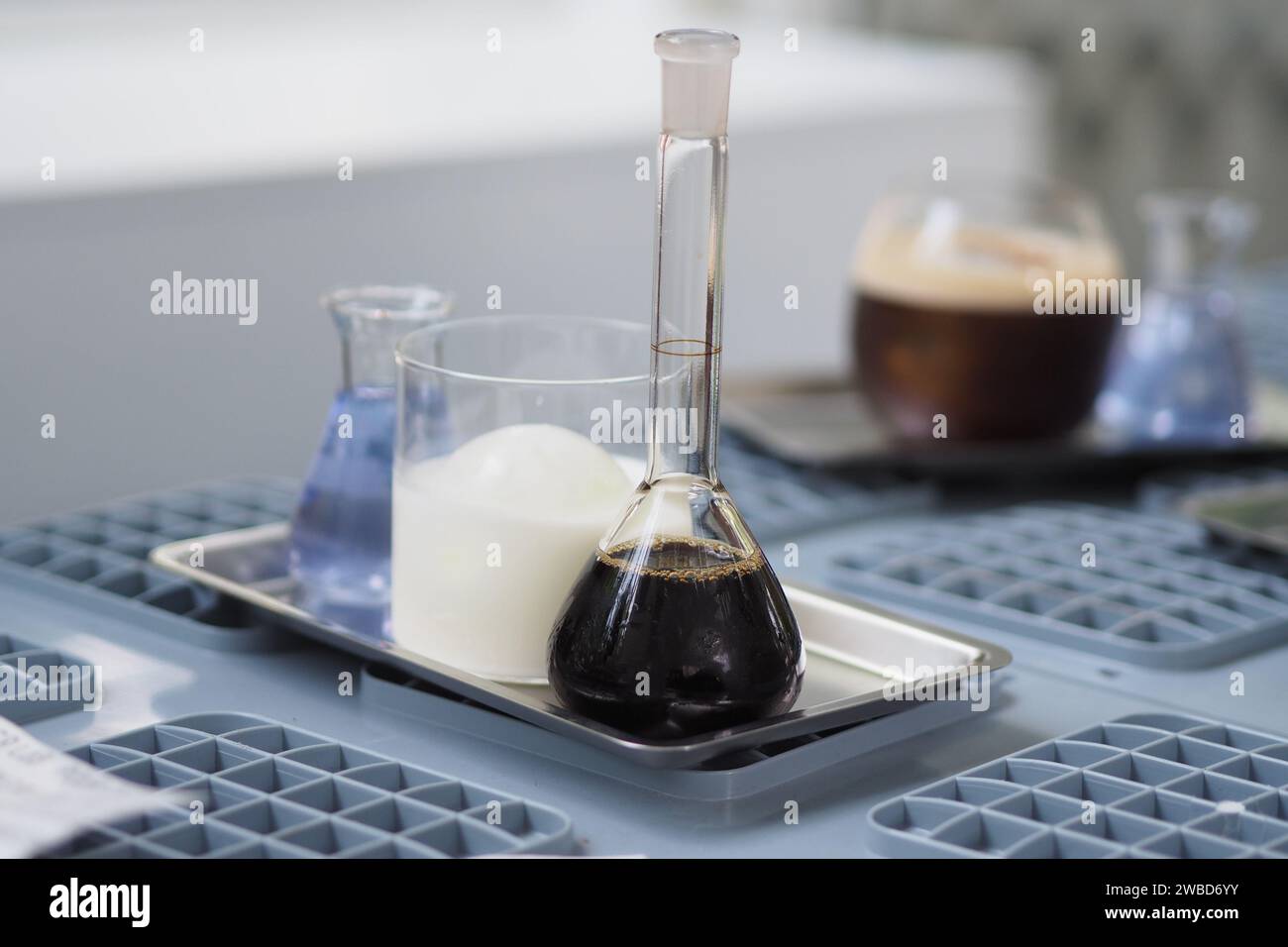 Coffee and milk served in a beager shaped container Stock Photo - Alamy