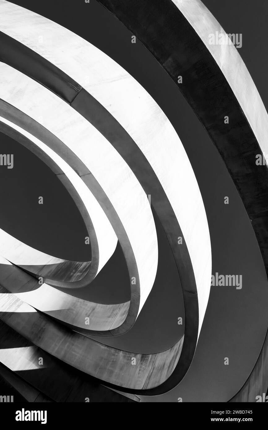 Striking monochrome architectural feature with sweeping curves and a dynamic interplay of light ...