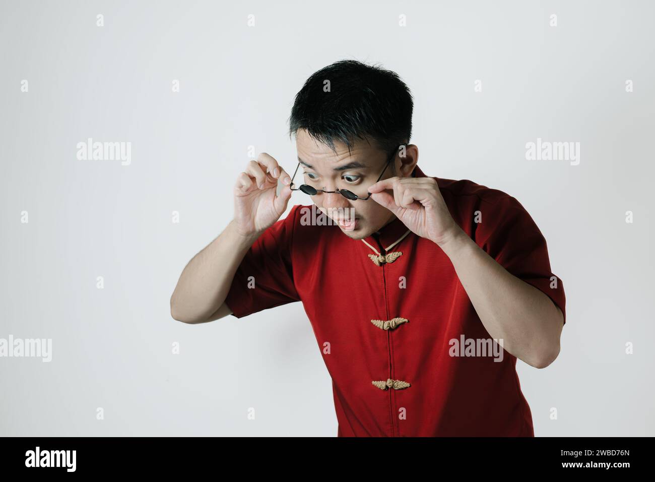 Shocked face of Asian man wearing traditional costume while looking ...