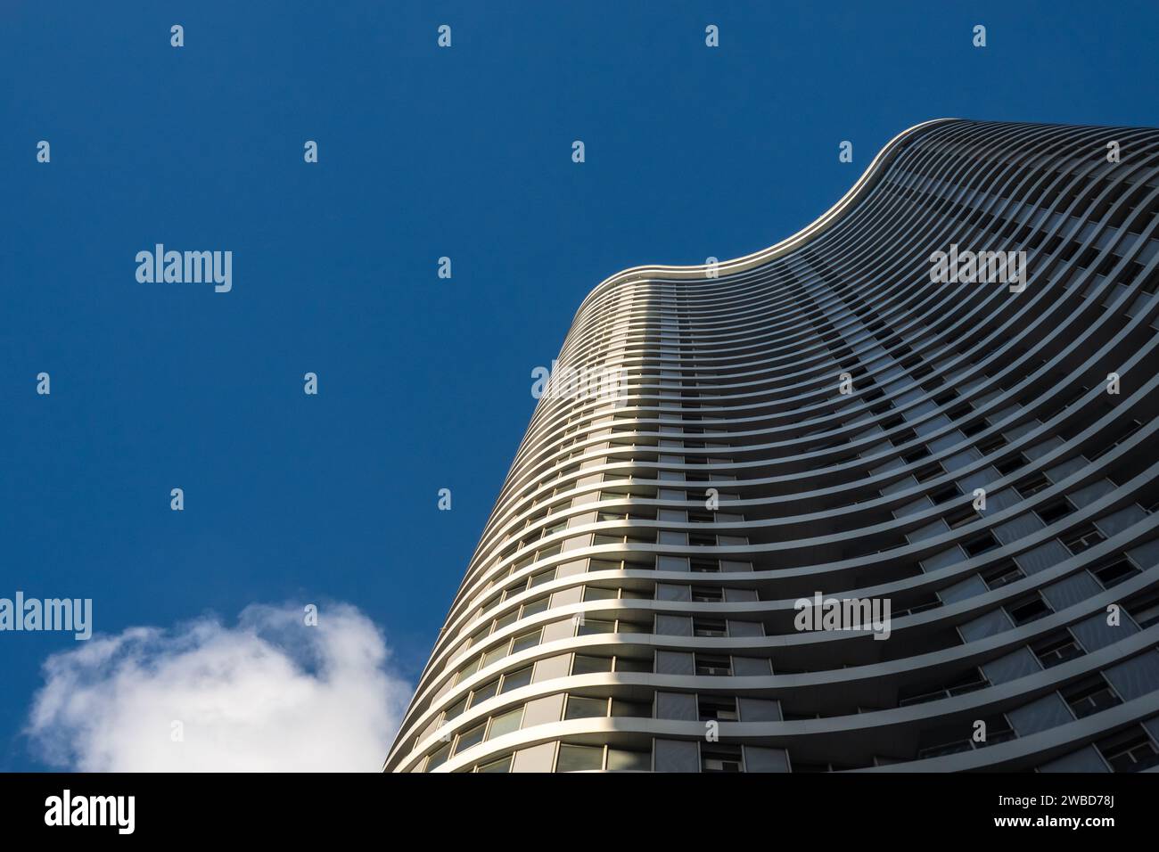 Curvilinear modern skyscrapers soar against a clear blue sky ...
