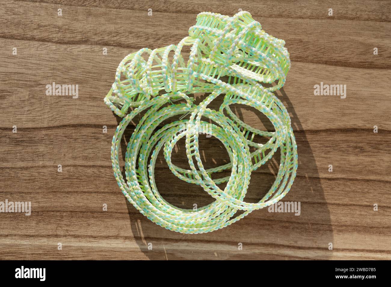 top view green plastic clothesline on a wood table Stock Photo - Alamy