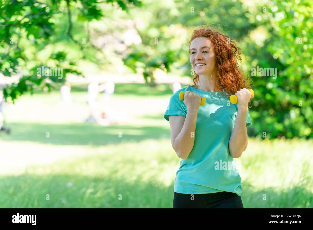 tired woman doing exercises with Dumbbells in public park Fitness ...