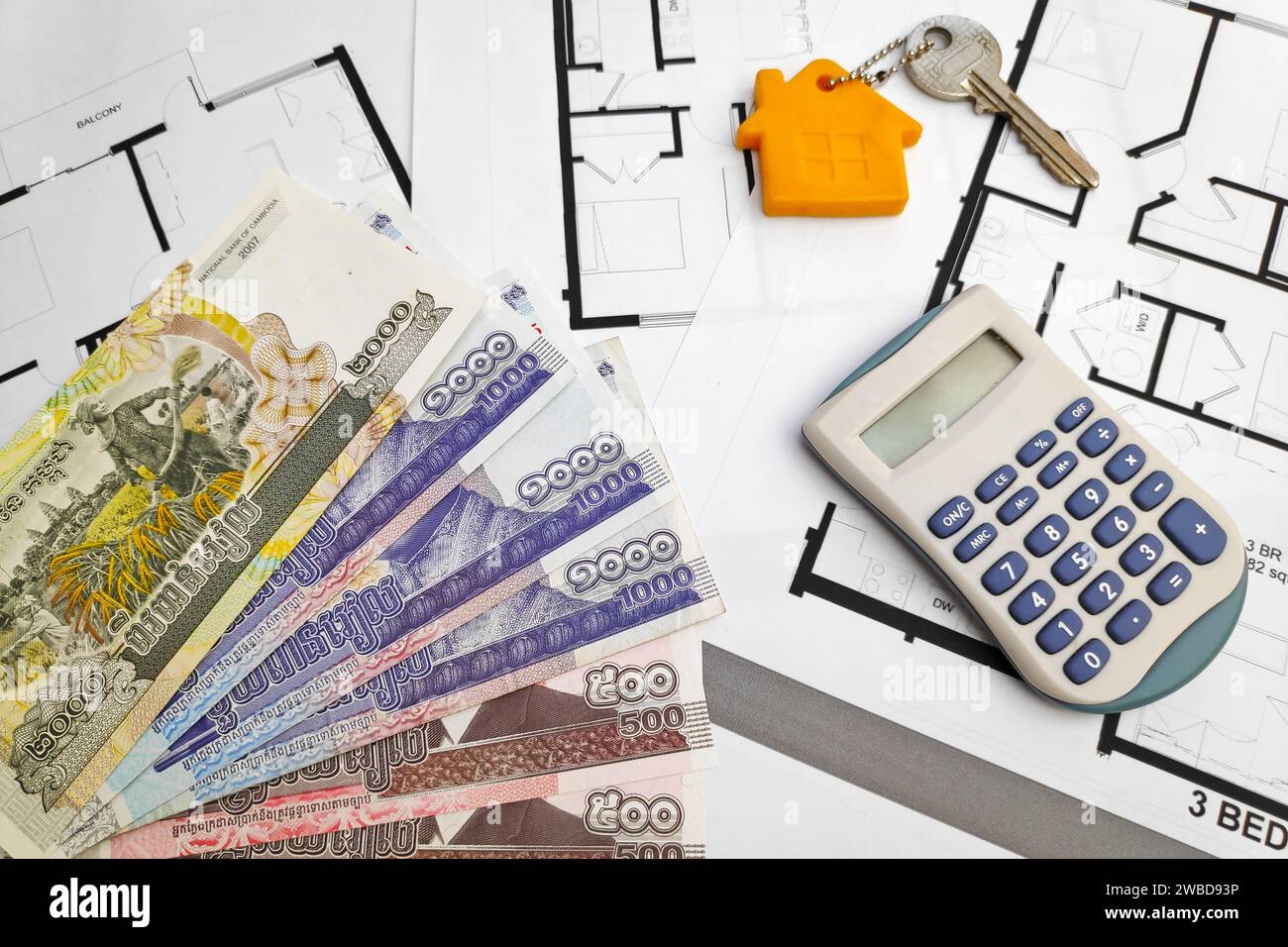 Close-up on some Cambodian Riel (KHR) banknotes, a home key and a ...